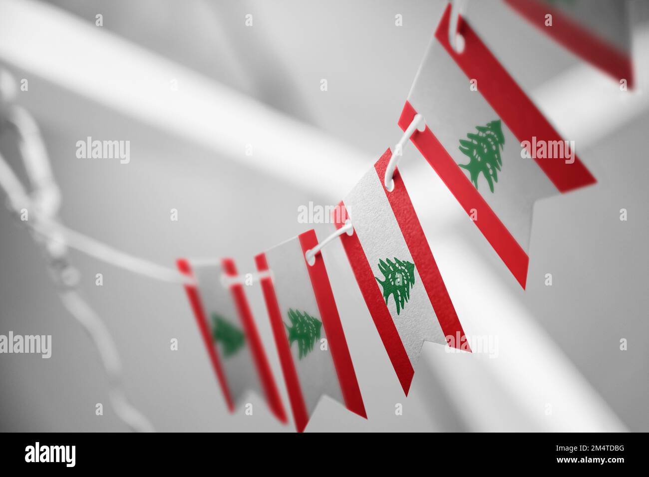 A garland of Lebanon national flags on an abstract blurred background ...