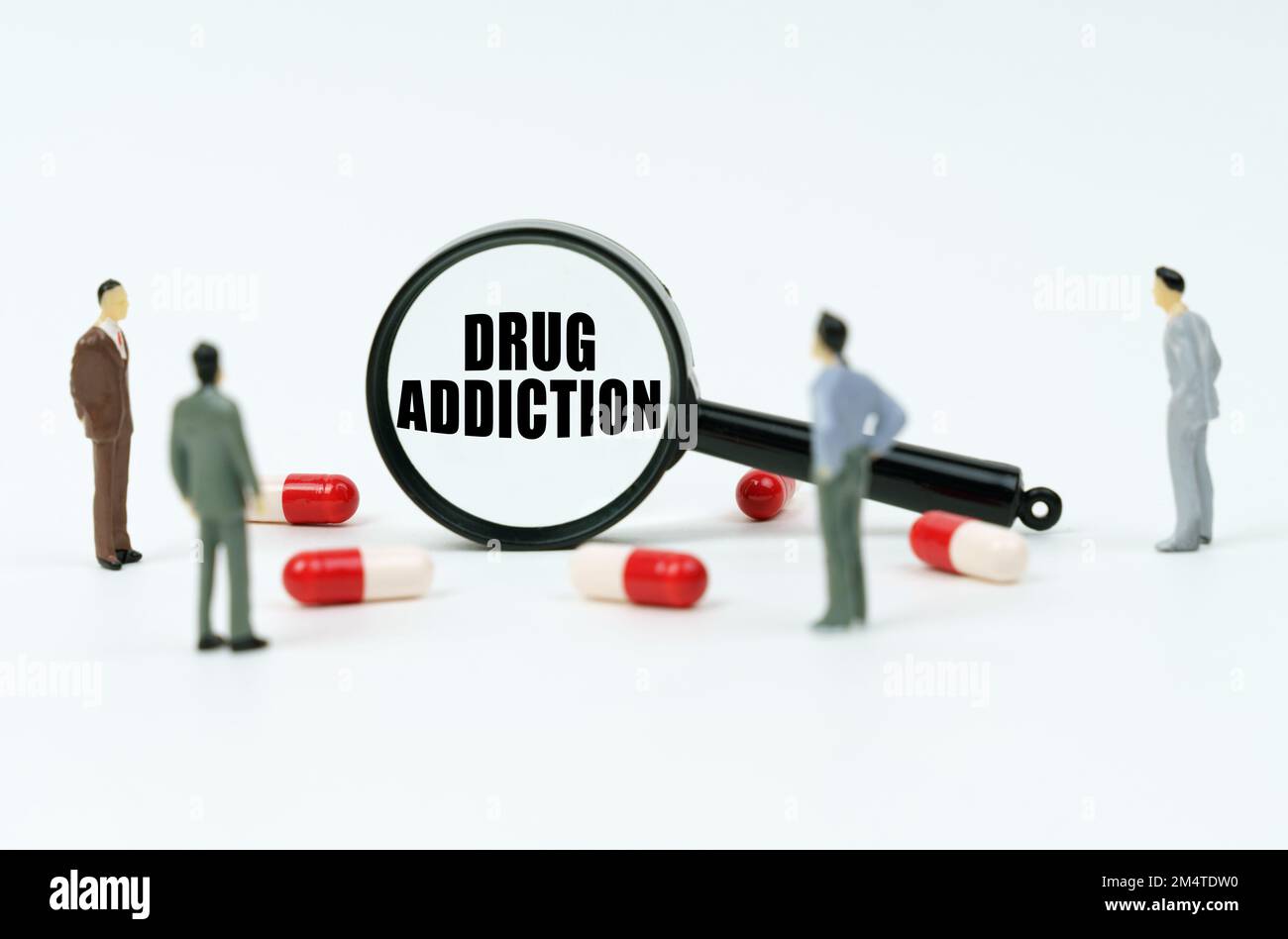 Medical concept. On a white surface are pills, figurines of people and ...