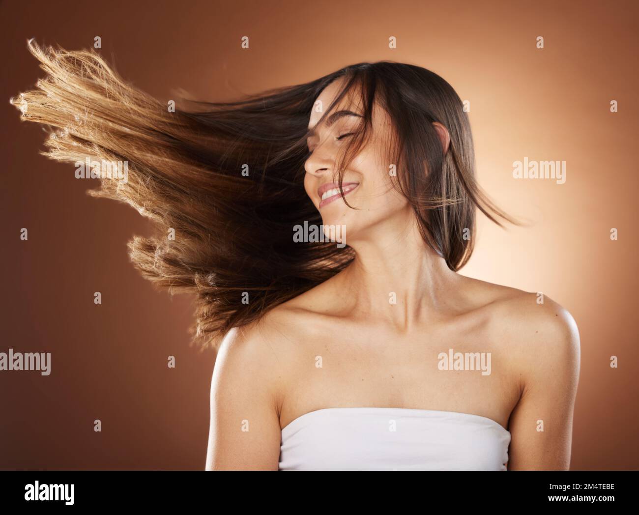 Hair, beauty and skincare with a model woman in studio on a brown ...