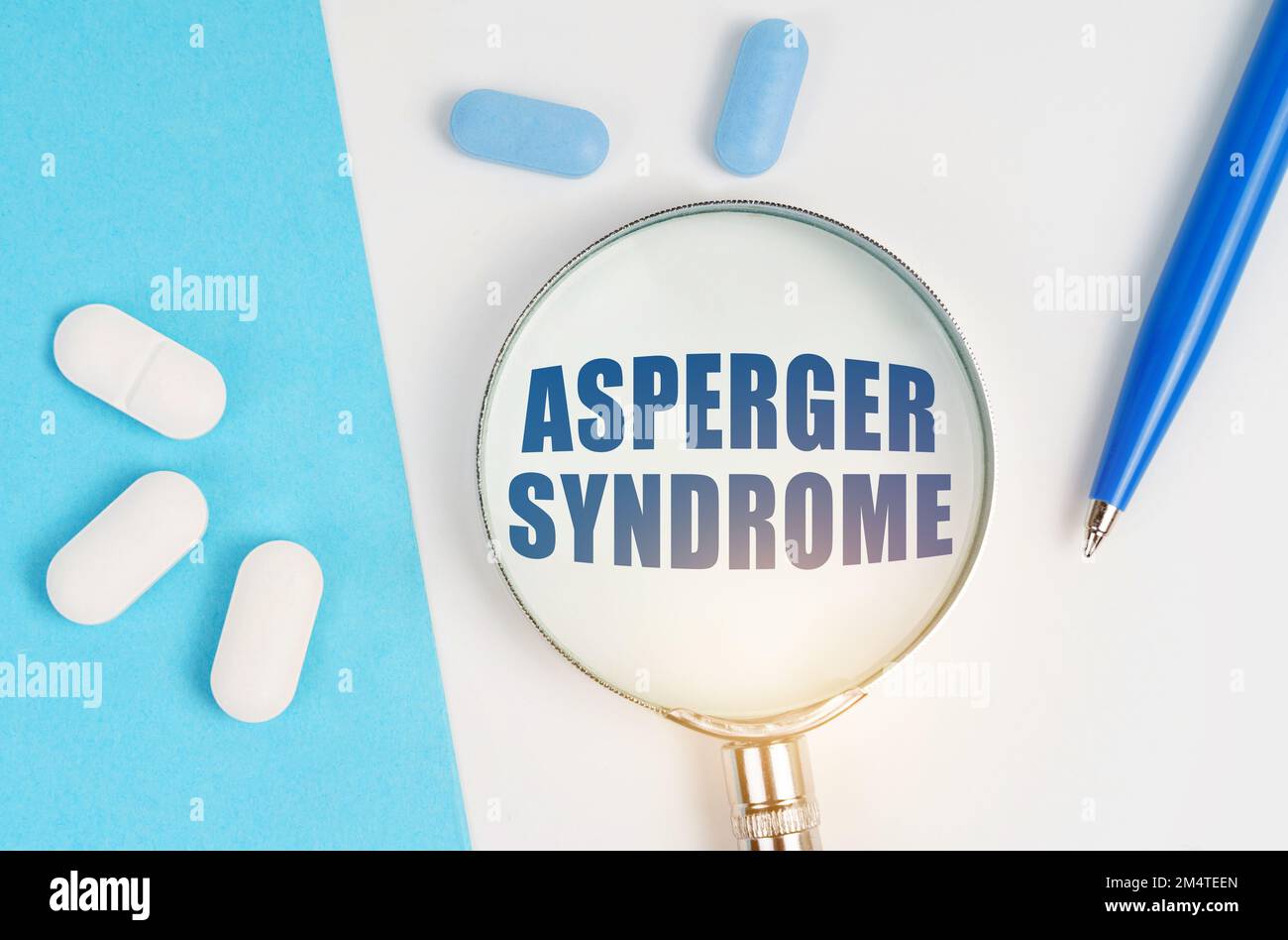Medical concept. On a white and blue surface are pills, a pen and a ...