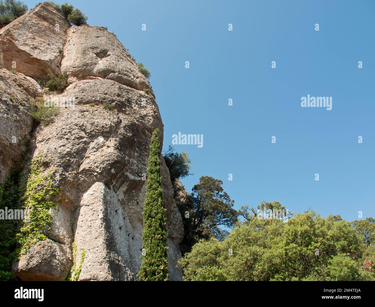 A Beautiful unusual shape of a mountain with green trees in Montserrat ...