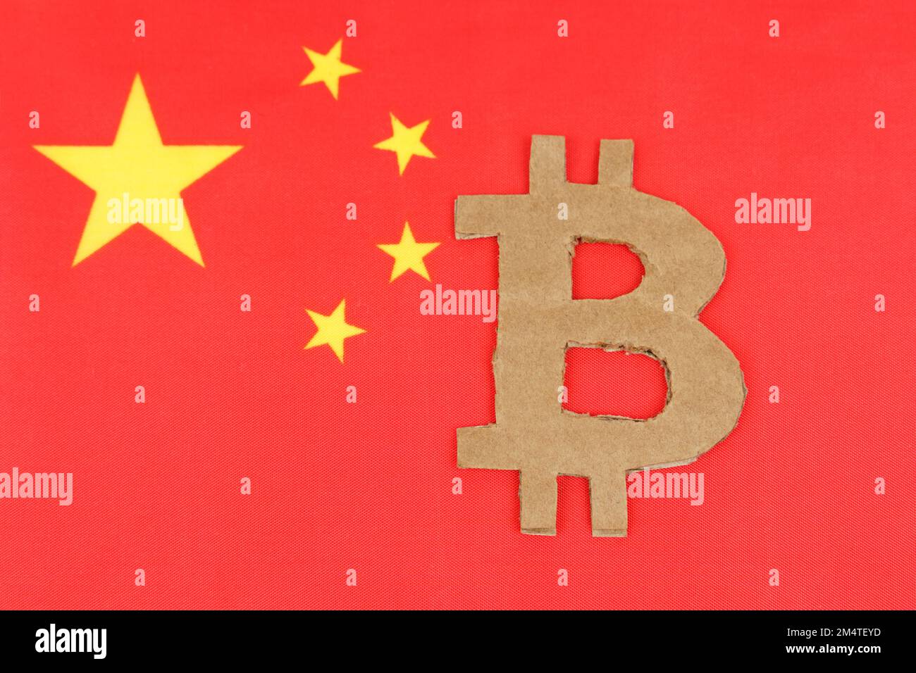 Cryptocurrency concept. On the background of the flag of China lies the ...