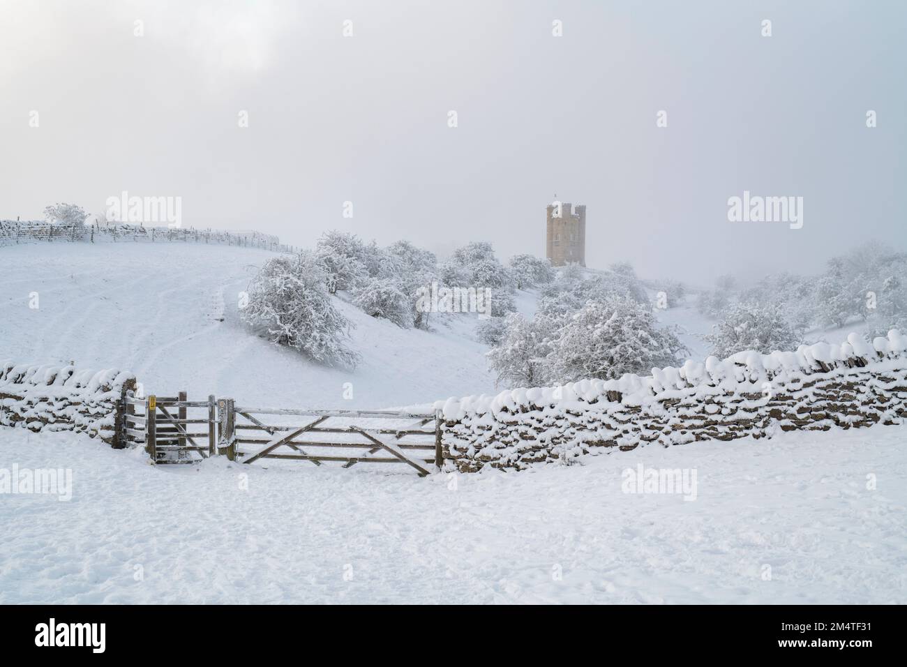 Broadway Tower in the early morning winter snow and fog along the ...