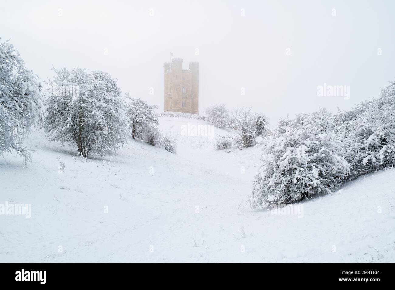 Broadway Tower in the early morning winter snow and fog along the ...