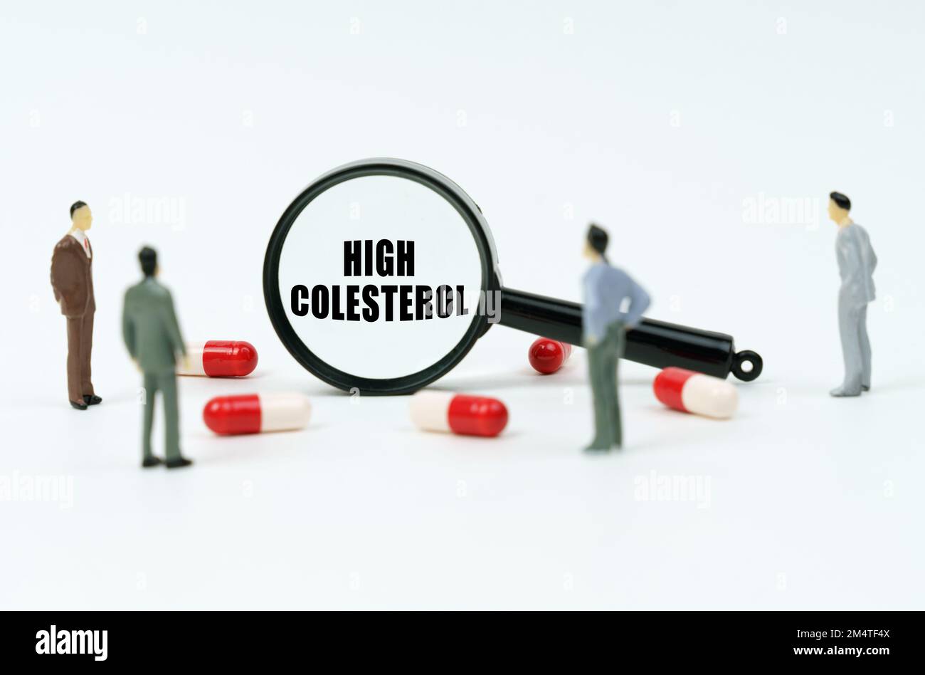 Medical concept. On a white surface are pills, figurines of people and ...