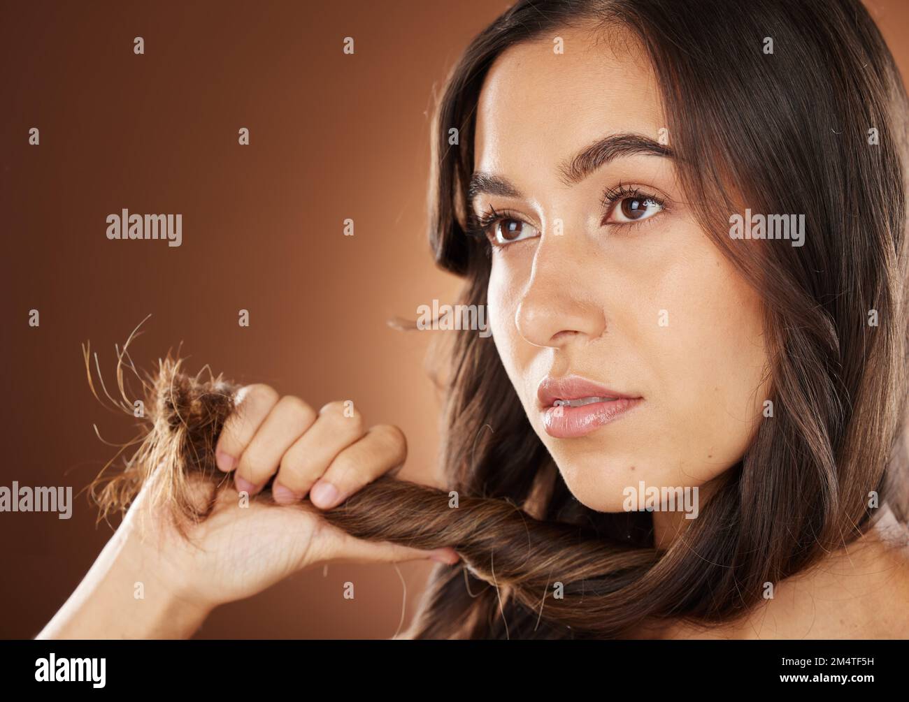 Hair, beauty and skincare with a model woman in studio on a brown ...