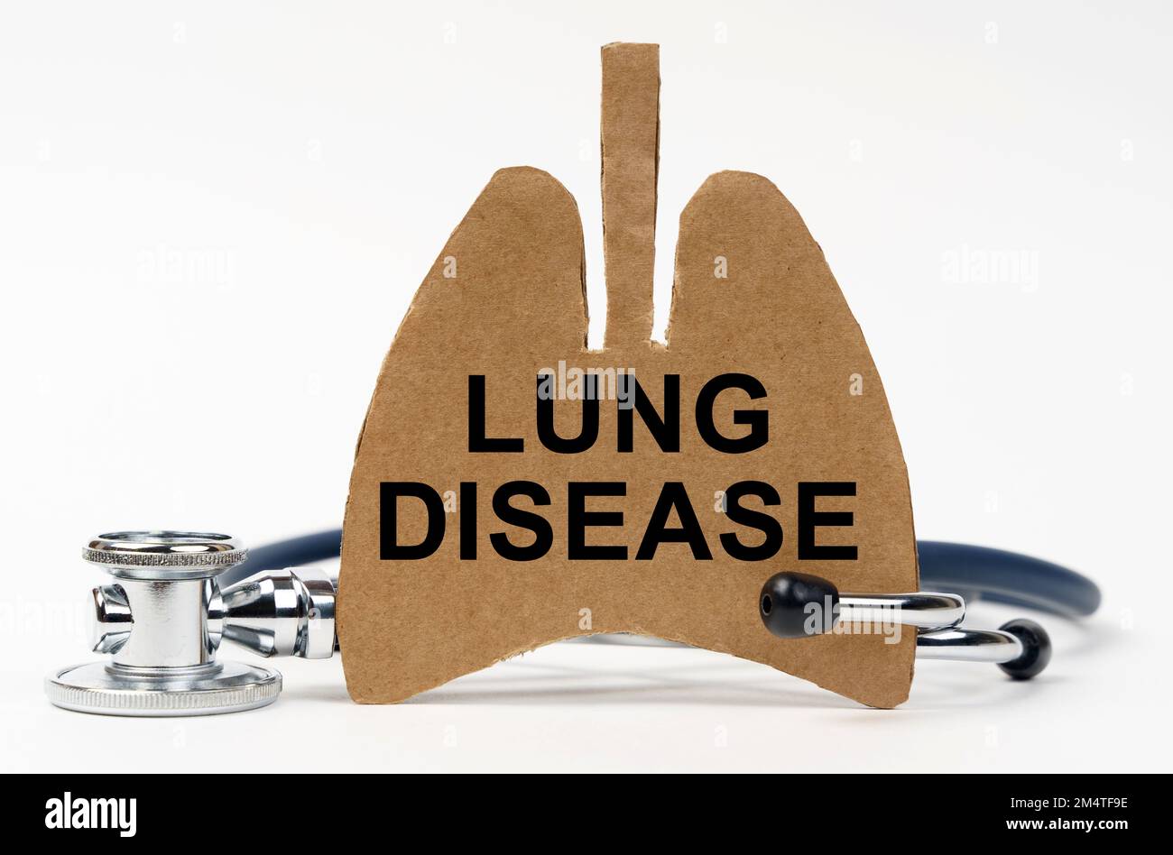 Medical concept. On a white surface are a stethoscope and a cardboard ...