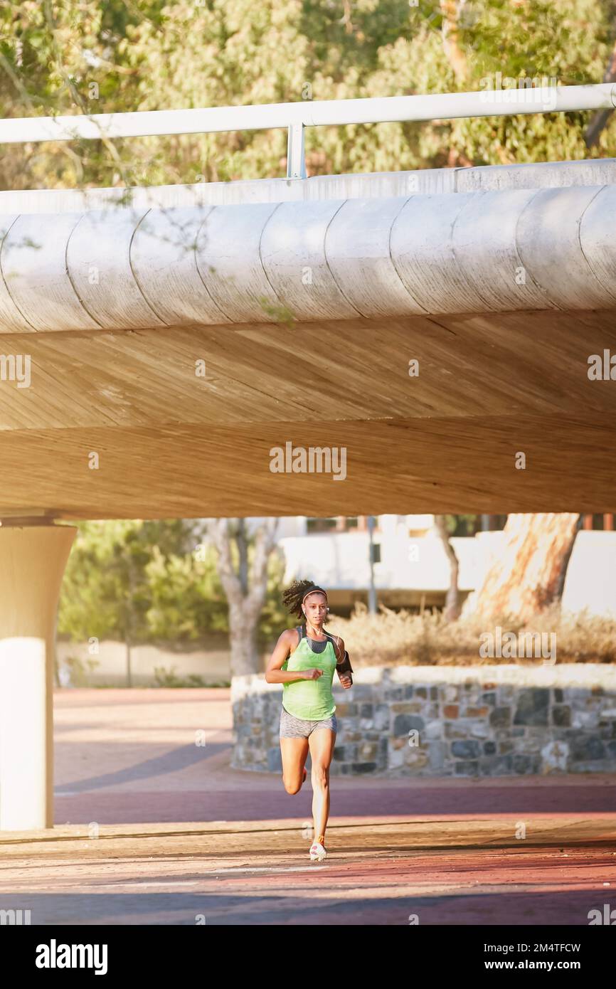 Keep on keeping on. a sporty young woman out for a run Stock Photo - Alamy