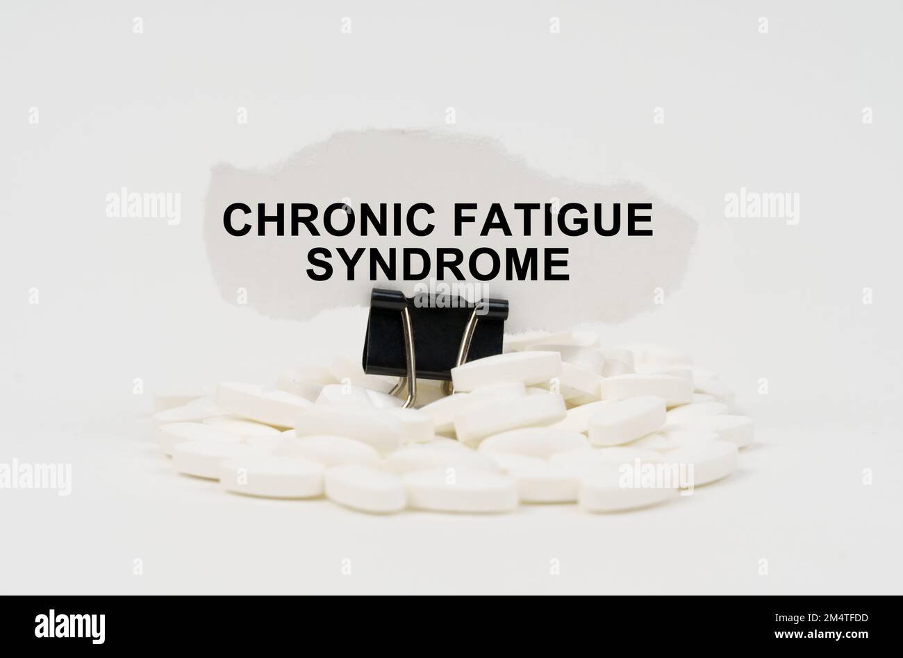 Medical concept. On a white surface are pills and torn paper with the ...