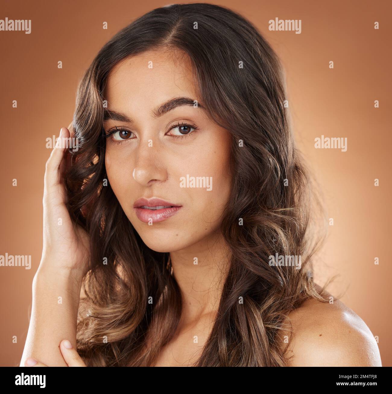 Woman, face skincare or curly hairstyle on brown studio background in color dye advertising ...