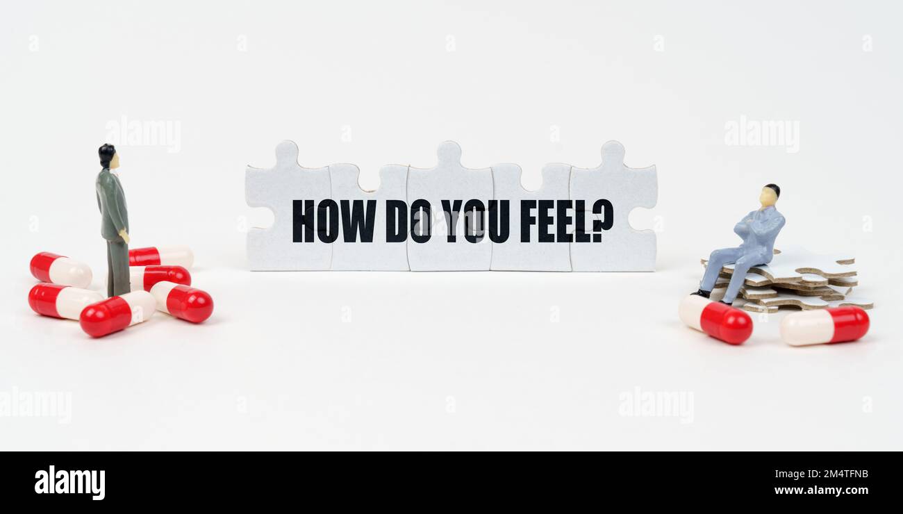 Medical concept. On the white surface of the tablet, miniature human ...