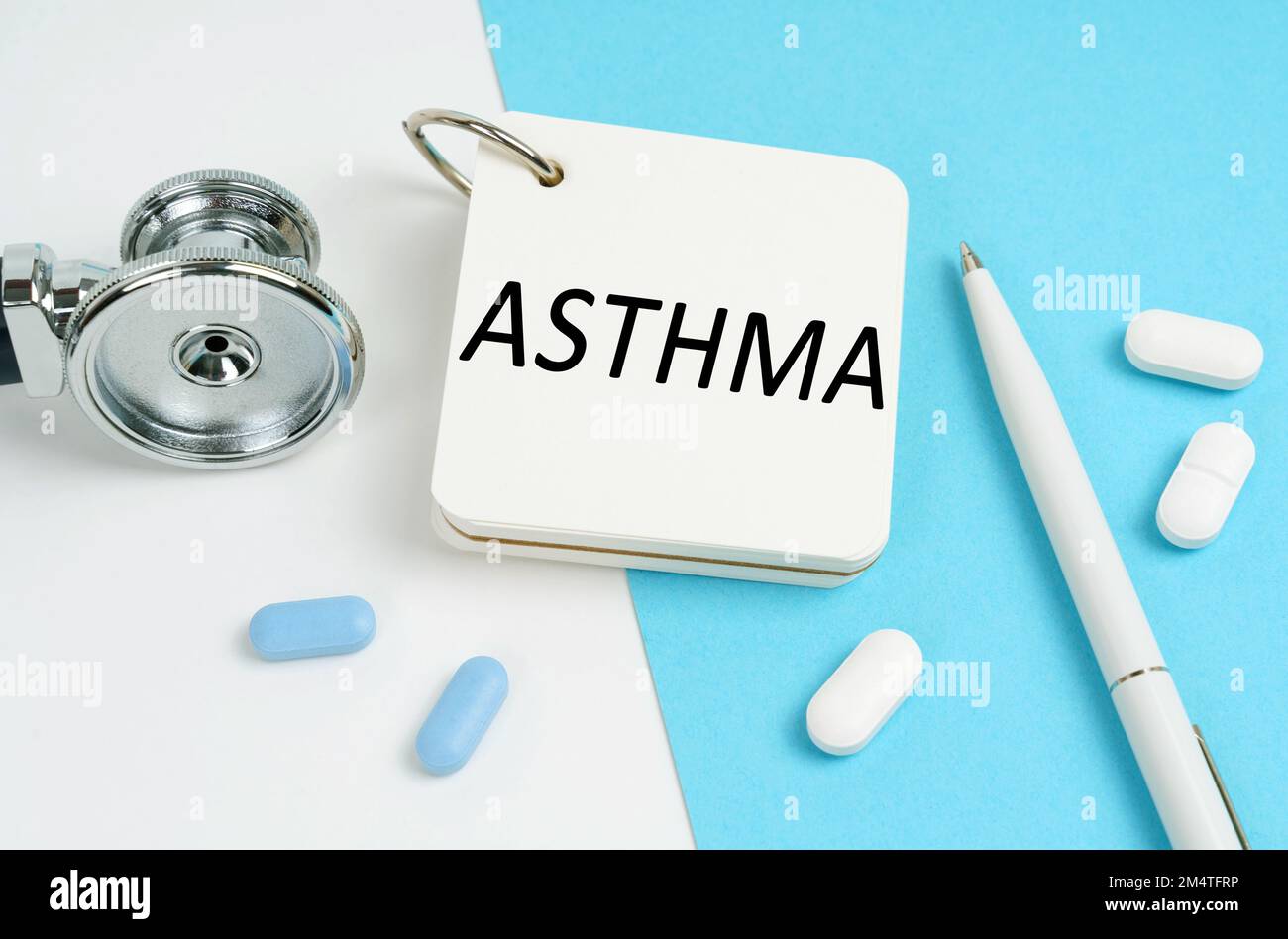 Medical concept. On a white and blue surface are pills, a stethoscope ...