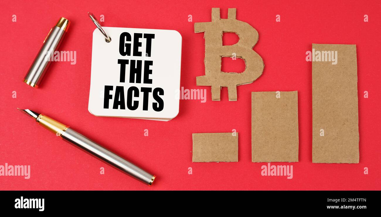 Business and bitcoin concept. On a red surface lie a bitcoin symbol, a ...