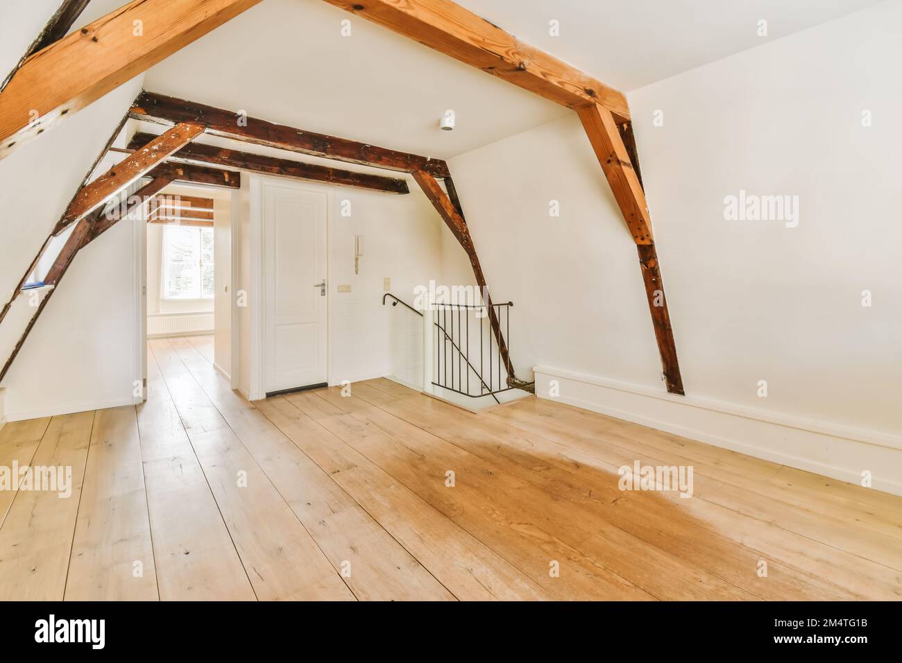an empty room with wood flooring and exposed beams on the ceiling in ...