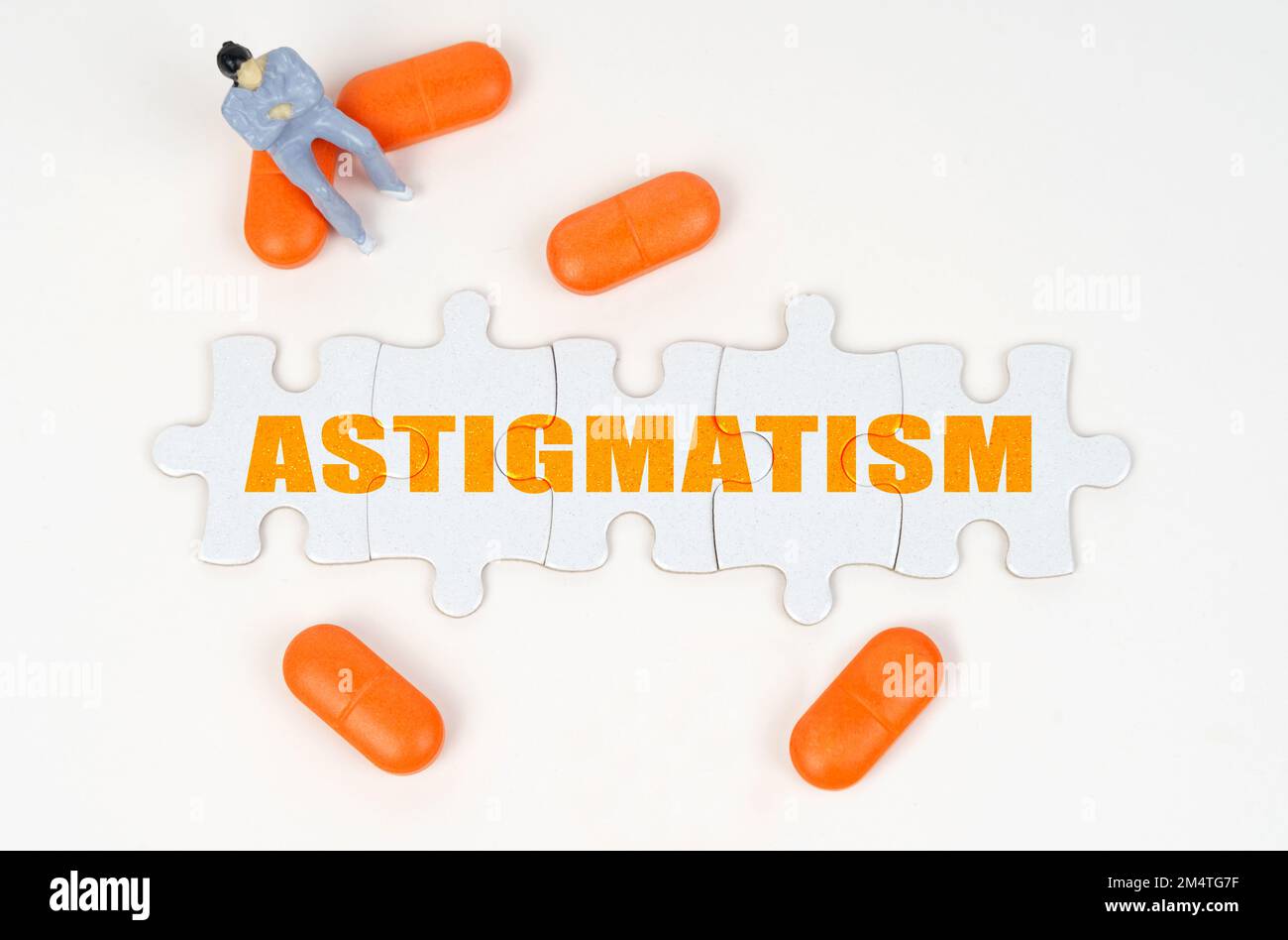 Medical concept. On the white surface of the tablet, a miniature human ...