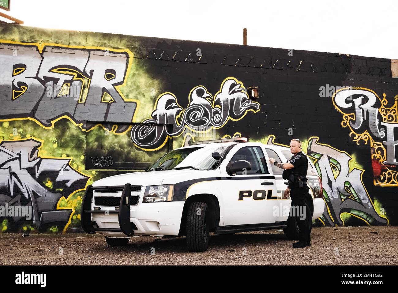 Horizontal image of white male caucasian police officer getting out of ...