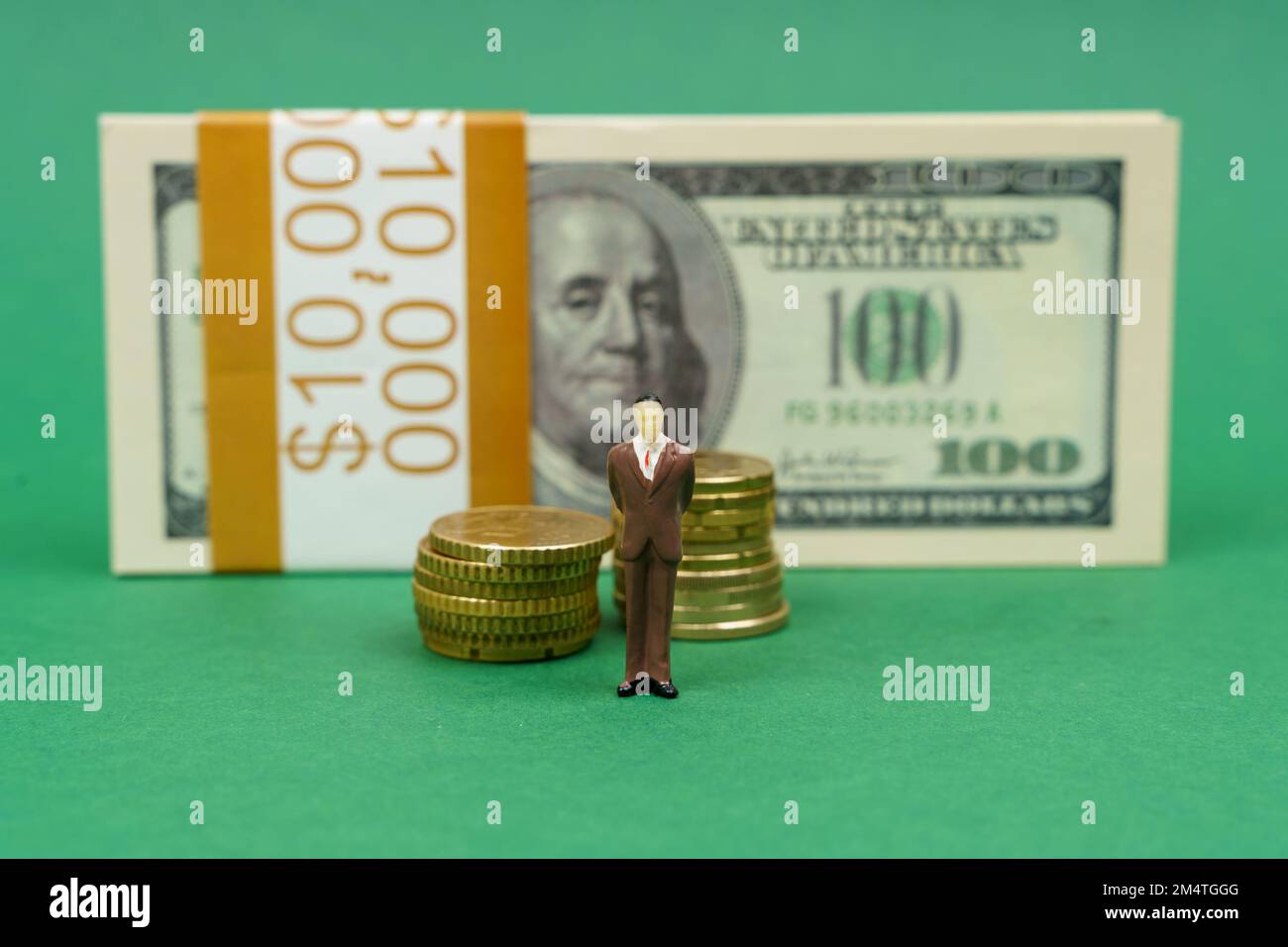 Economic concept. Miniatures. On the green surface is a pack of dollars ...