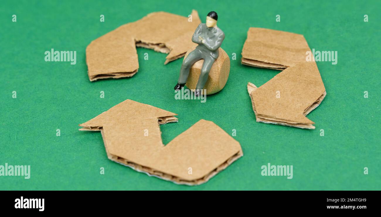 Ecological concept. On the green surface lies the symbol of recycling ...