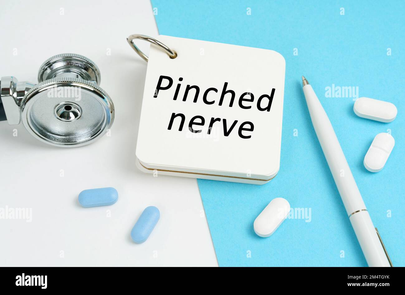 Medical concept. On a white and blue surface are pills, a stethoscope ...