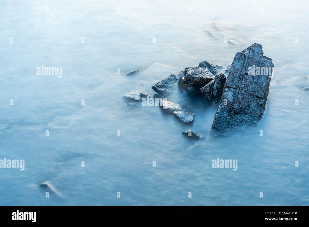 A high-angle view of steam and snow covering the pile of stones Stock ...