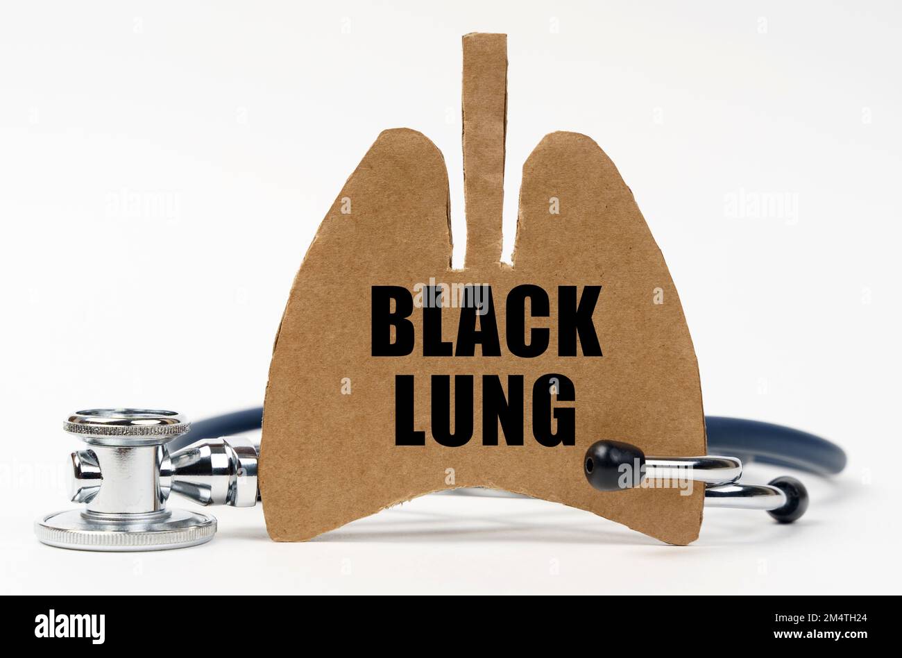 Medical concept. On a white surface are a stethoscope and a cardboard ...