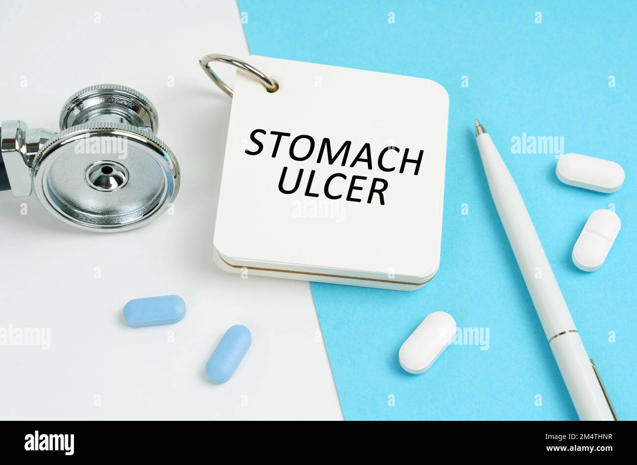 Medical concept. On a white and blue surface are pills, a stethoscope ...