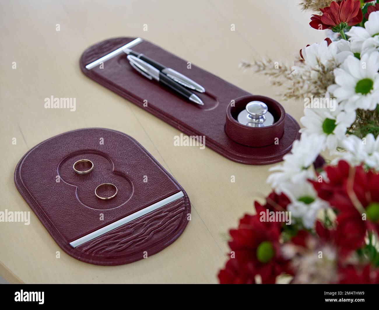 Gold wedding rings, pens and stamp on the table. Wedding concept Stock ...