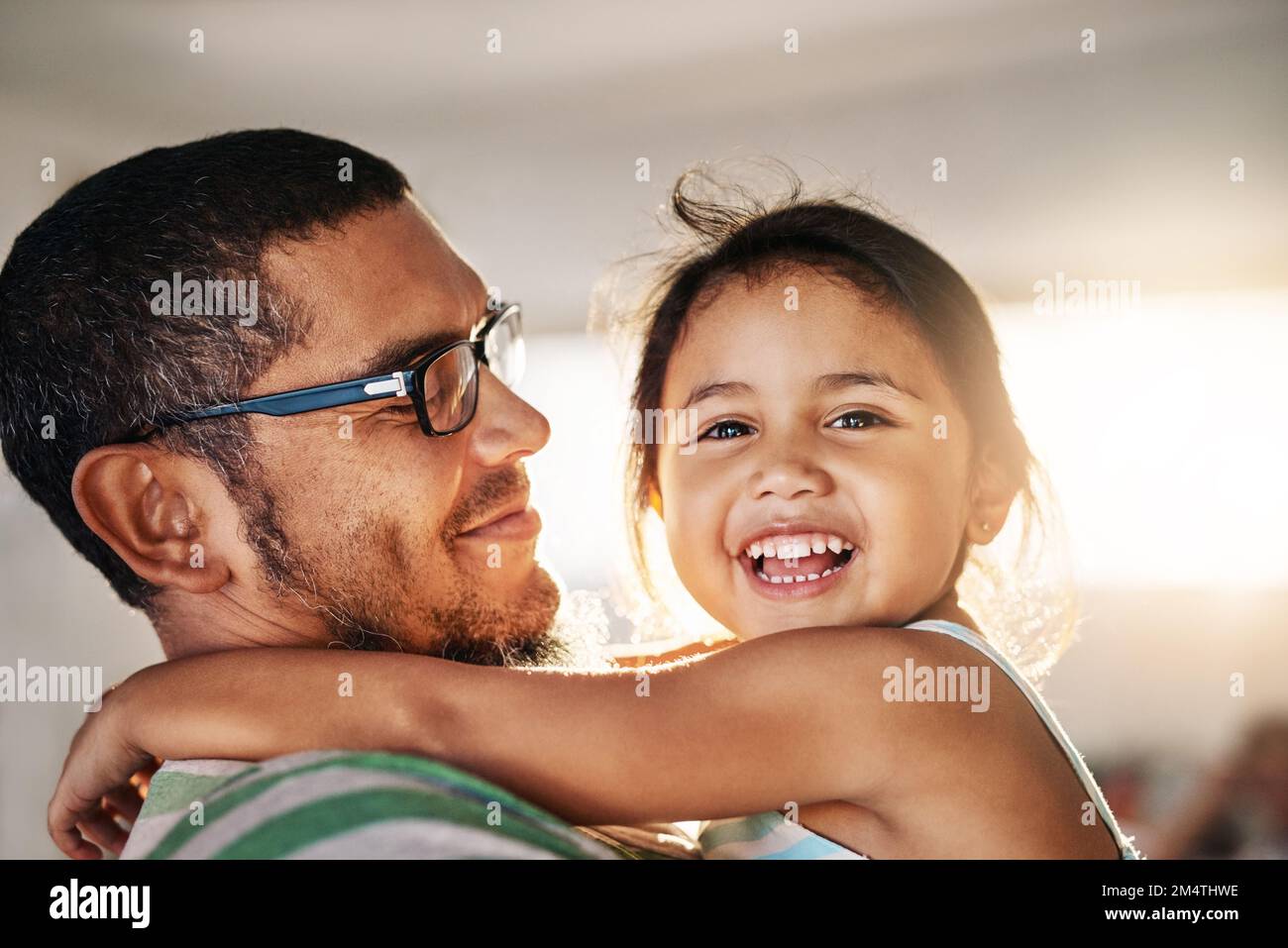 Such a happy girl. Portrait of a cheerful little girl being held in her ...