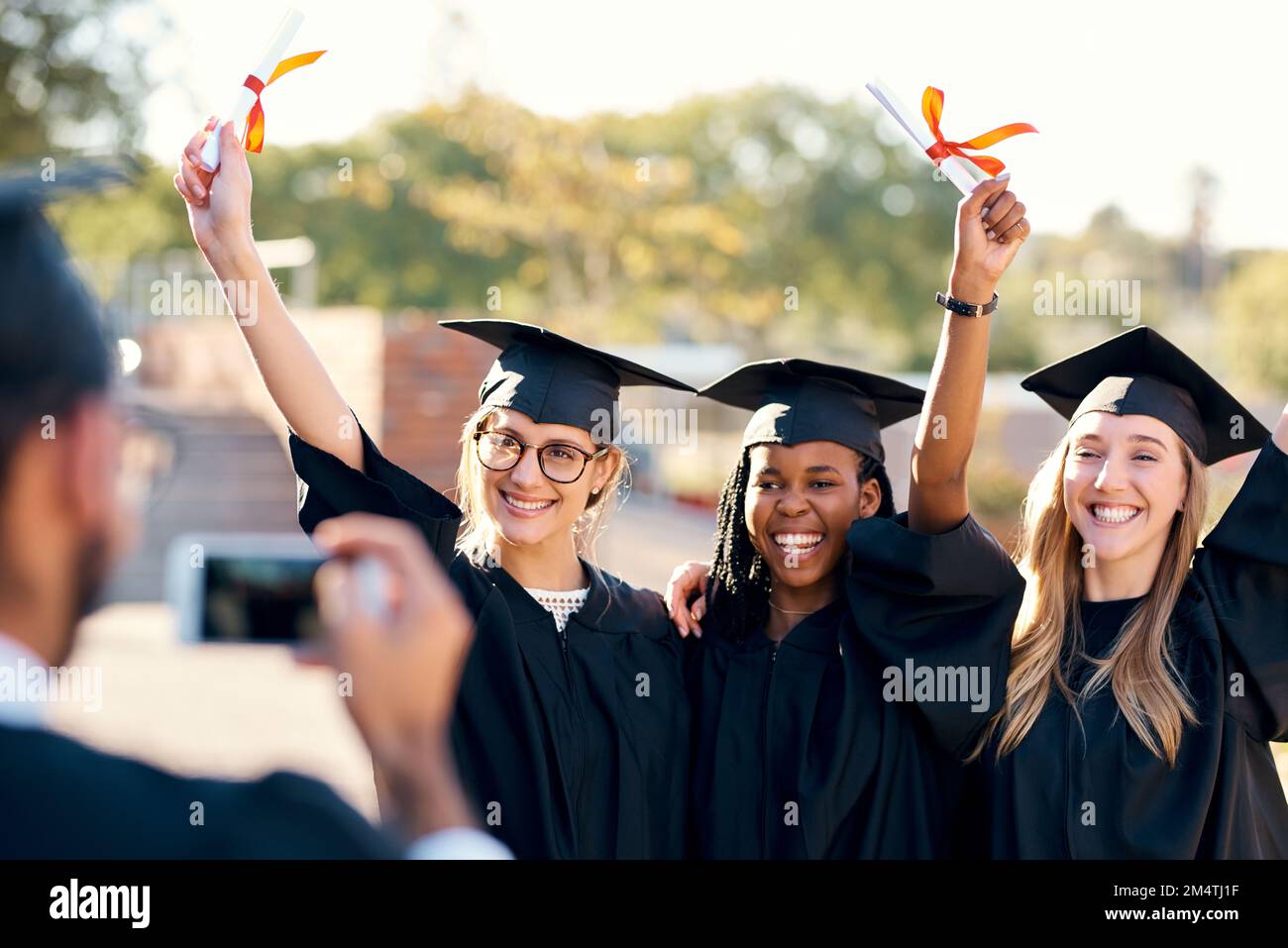 Its a day for celebration. a group of students taking photos on ...