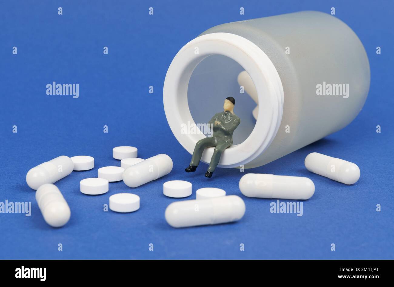 The concept of healthcare and medicine. A miniature figure of a man ...