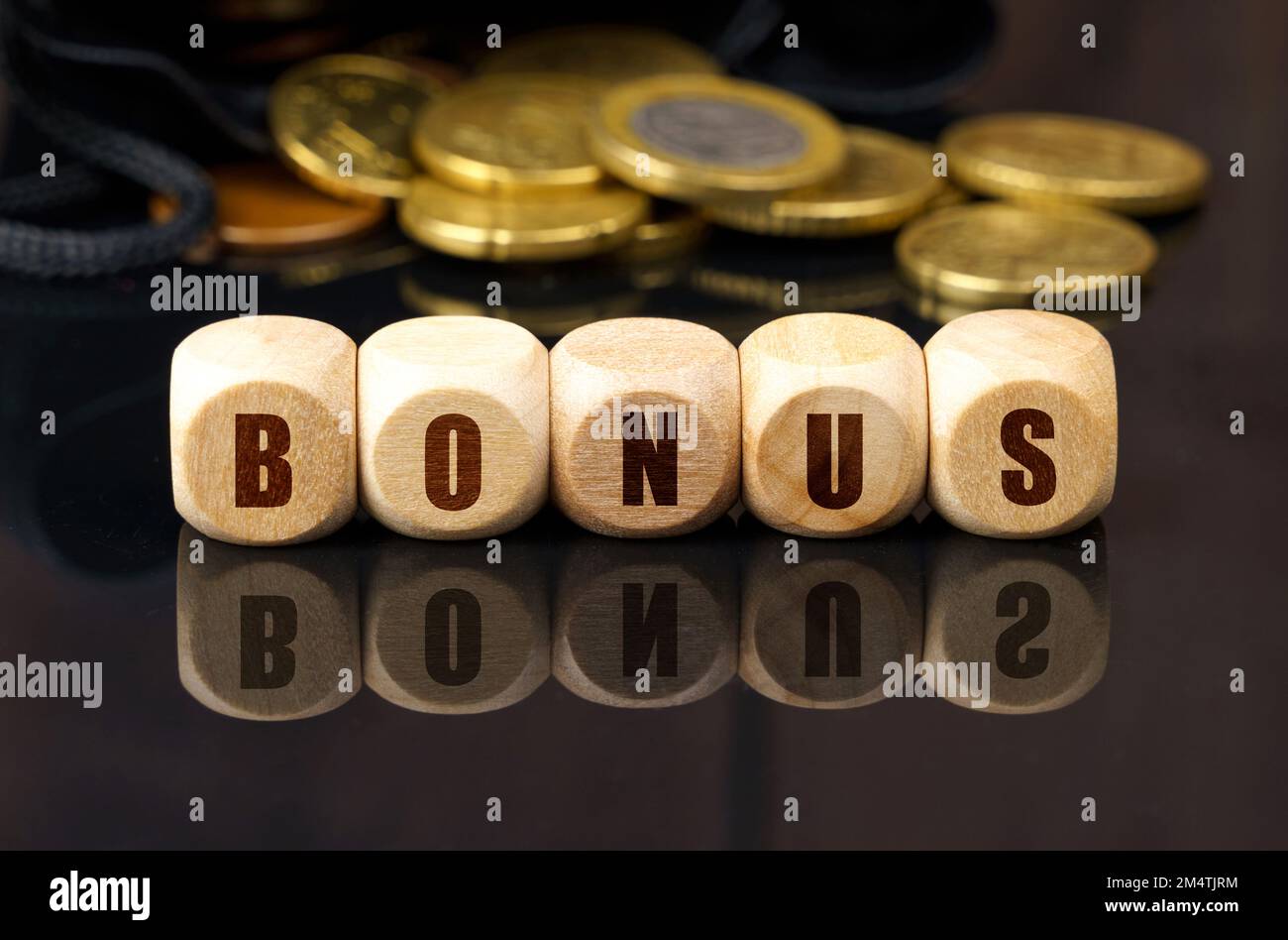 Business and economy concept. On a black reflective surface are coins ...