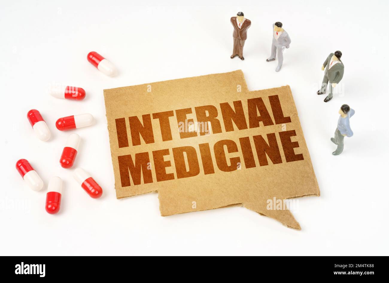 Medical concept. On a white surface are pills, a pen, miniature ...