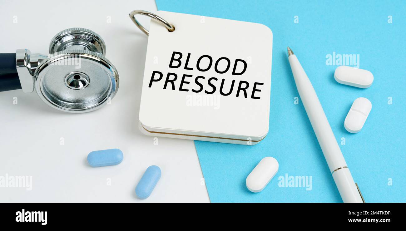 Medical concept. On a white and blue surface are pills, a stethoscope ...