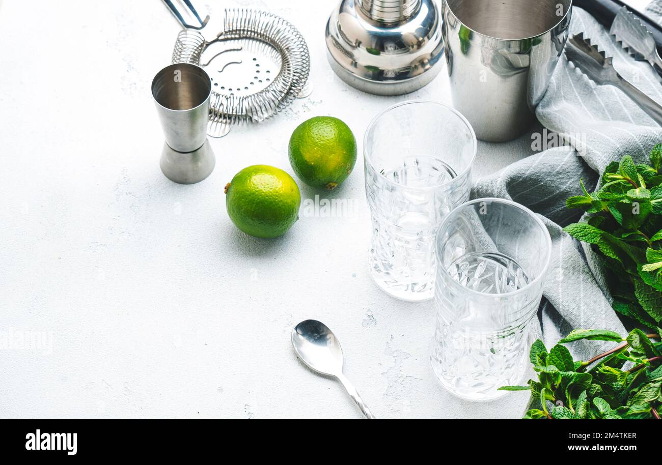 Mojito cocktail making. Mint, lime, ice - ingredients and steel bar ...