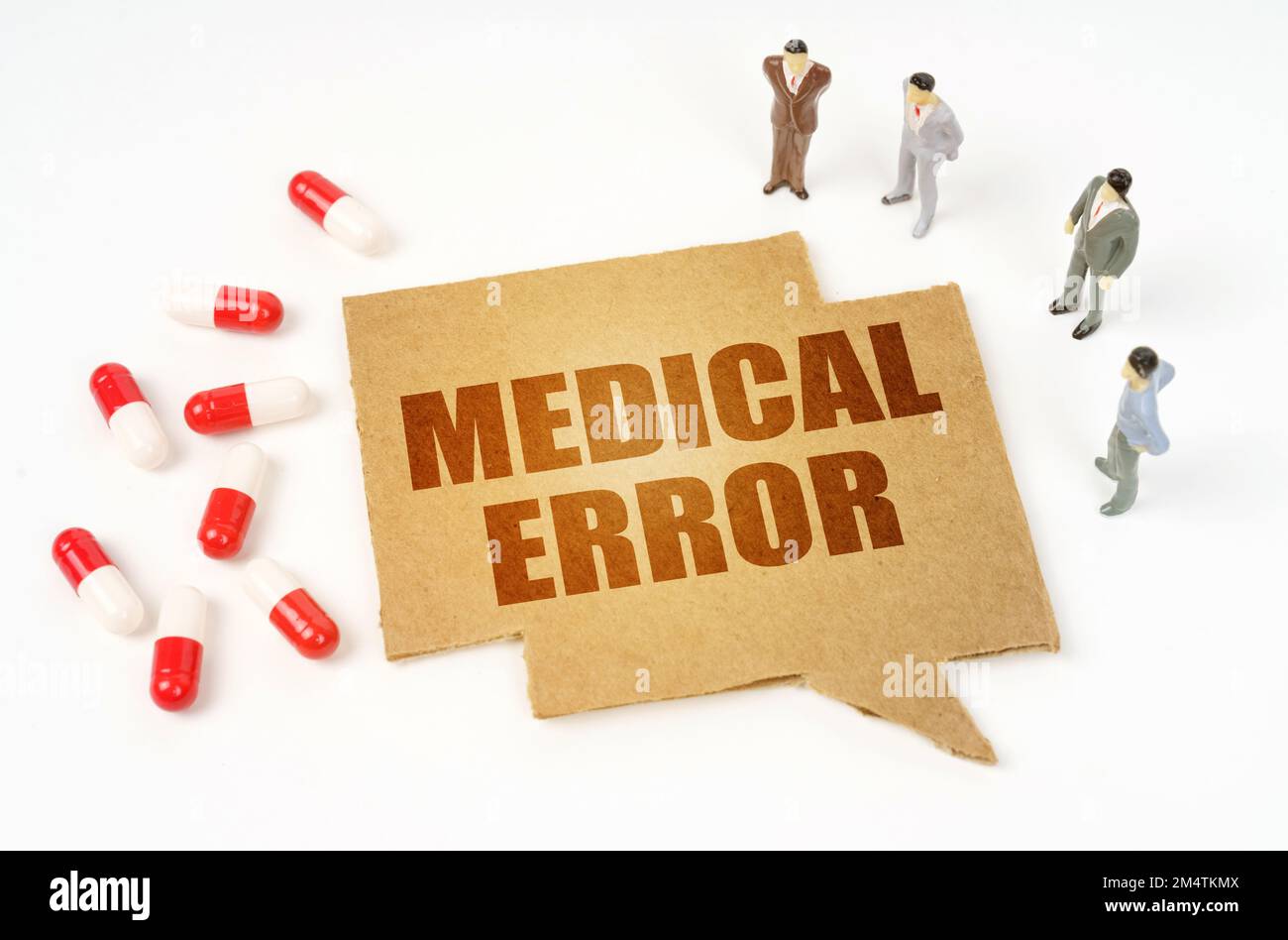 Medical concept. On a white surface are pills, a pen, miniature ...