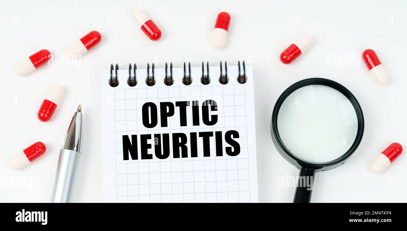 Medical concept. On a white surface are tablets, a pen, a magnifying ...