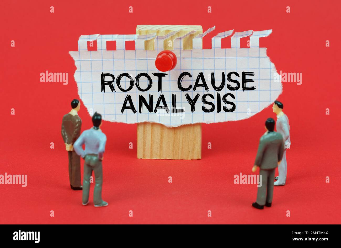 Business concept. On a red background are miniature figures of people ...