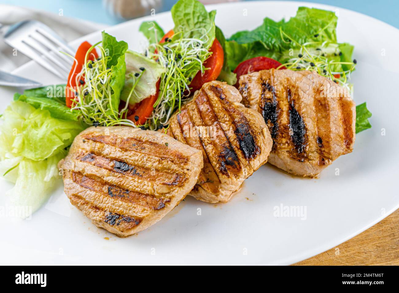Meat with vegetables. Pork medallions. Grilled meat. Cutlets close-up ...