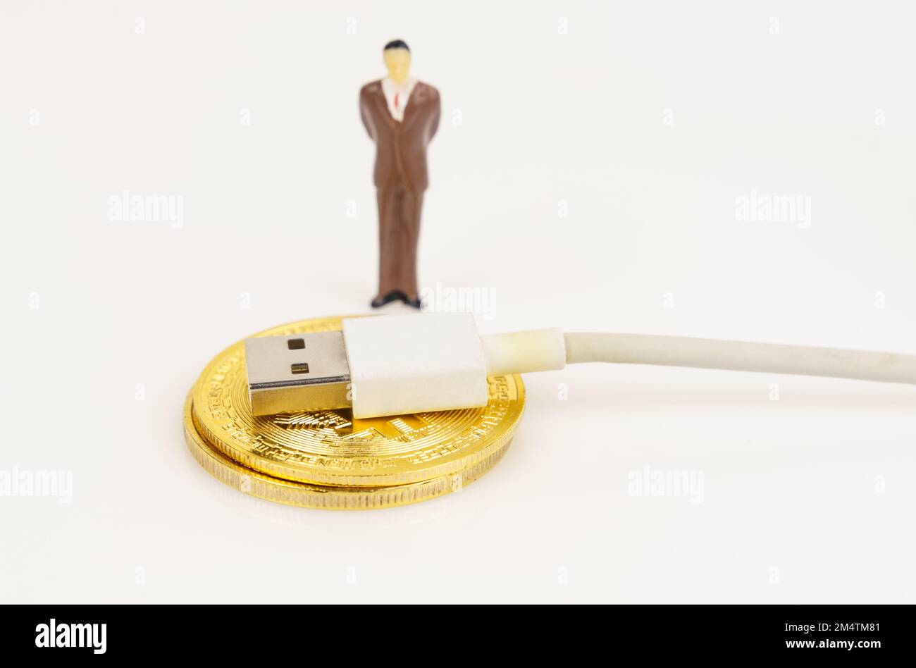 Cryptocurrency and business concept. On a white surface are a bitcoin ...