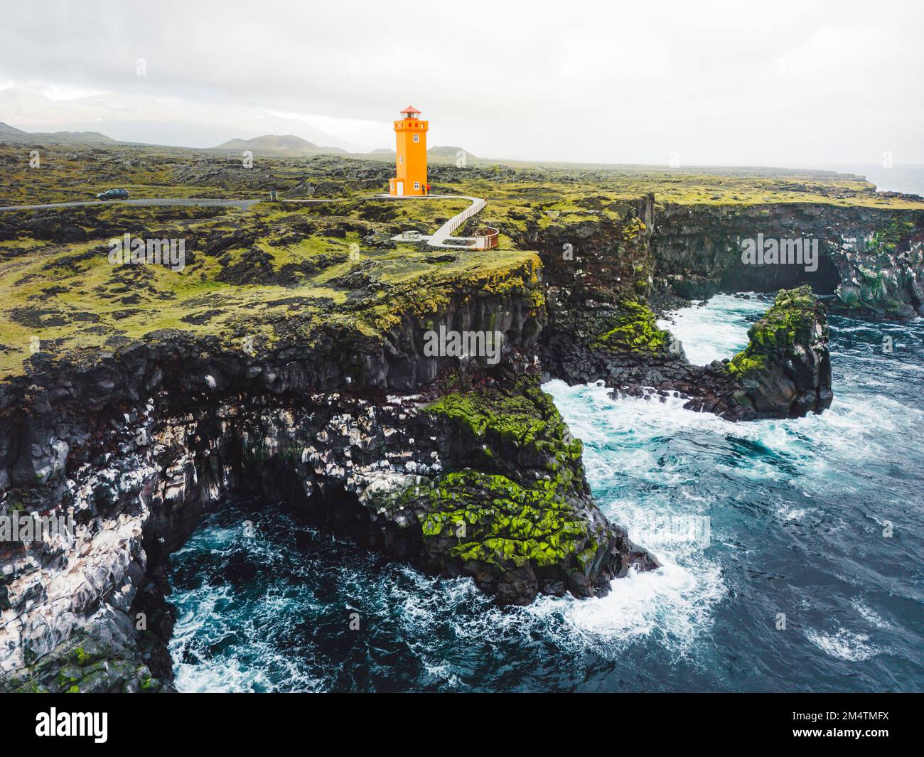 Svortuloft Lighthouse in west Iceland highlands with stormy sea down ...
