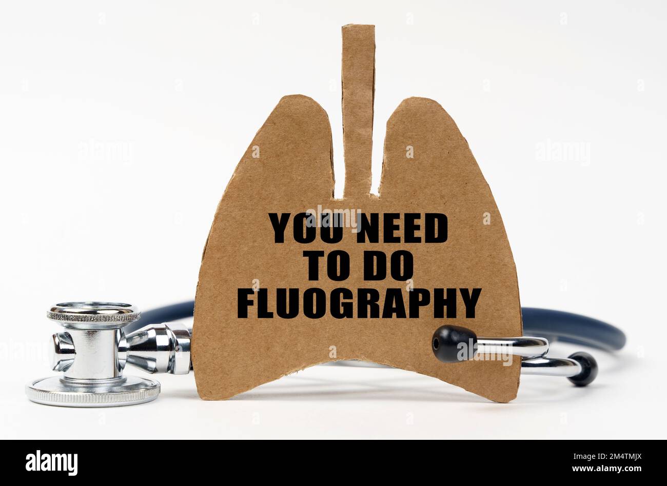 Medical concept. On a white surface are a stethoscope and a cardboard ...