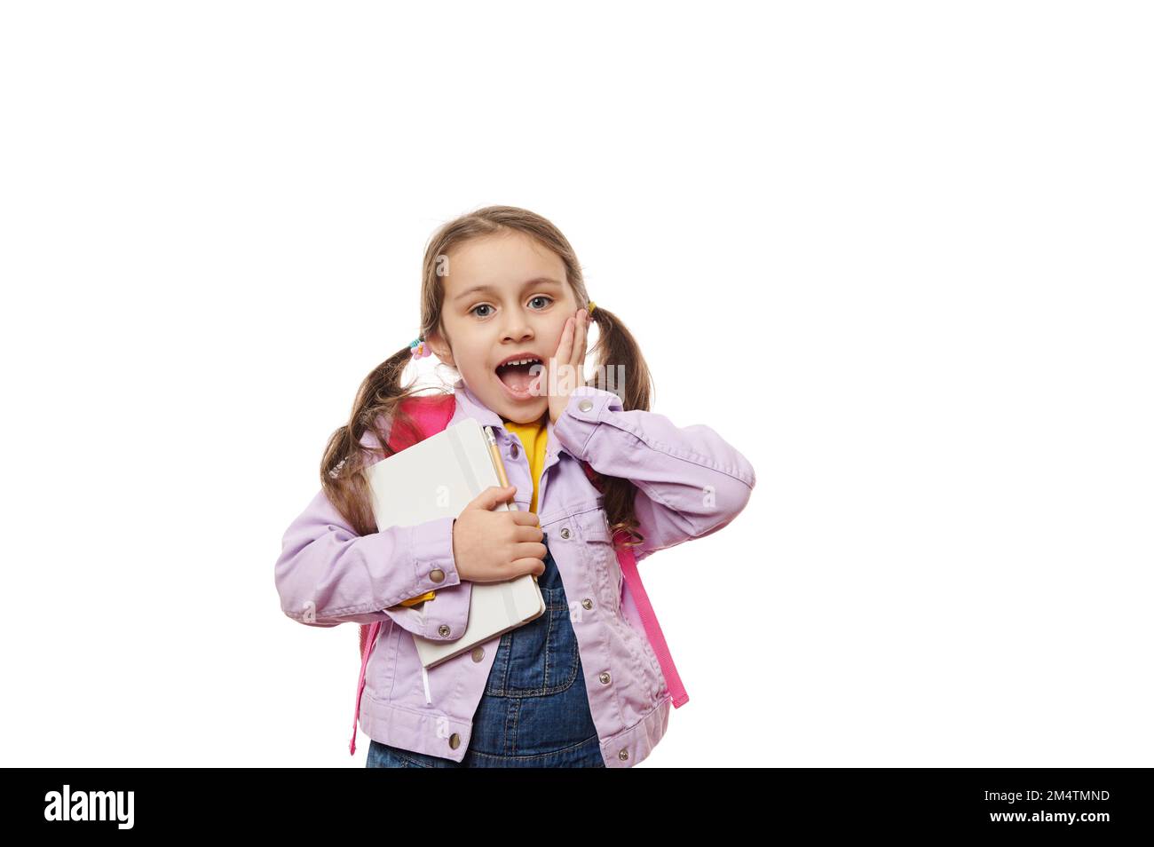 Surprised Caucasian little girl, a first grade student with wow ...