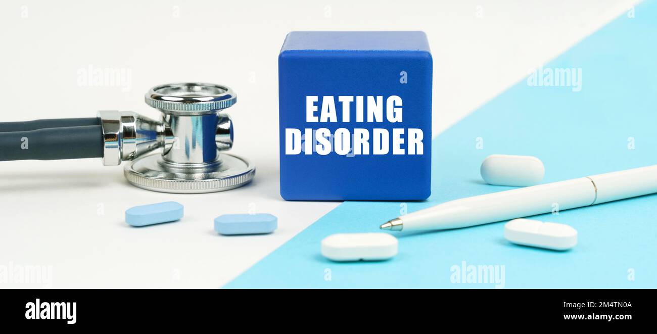 Medical concept. On a white and blue surface are pills, a stethoscope ...