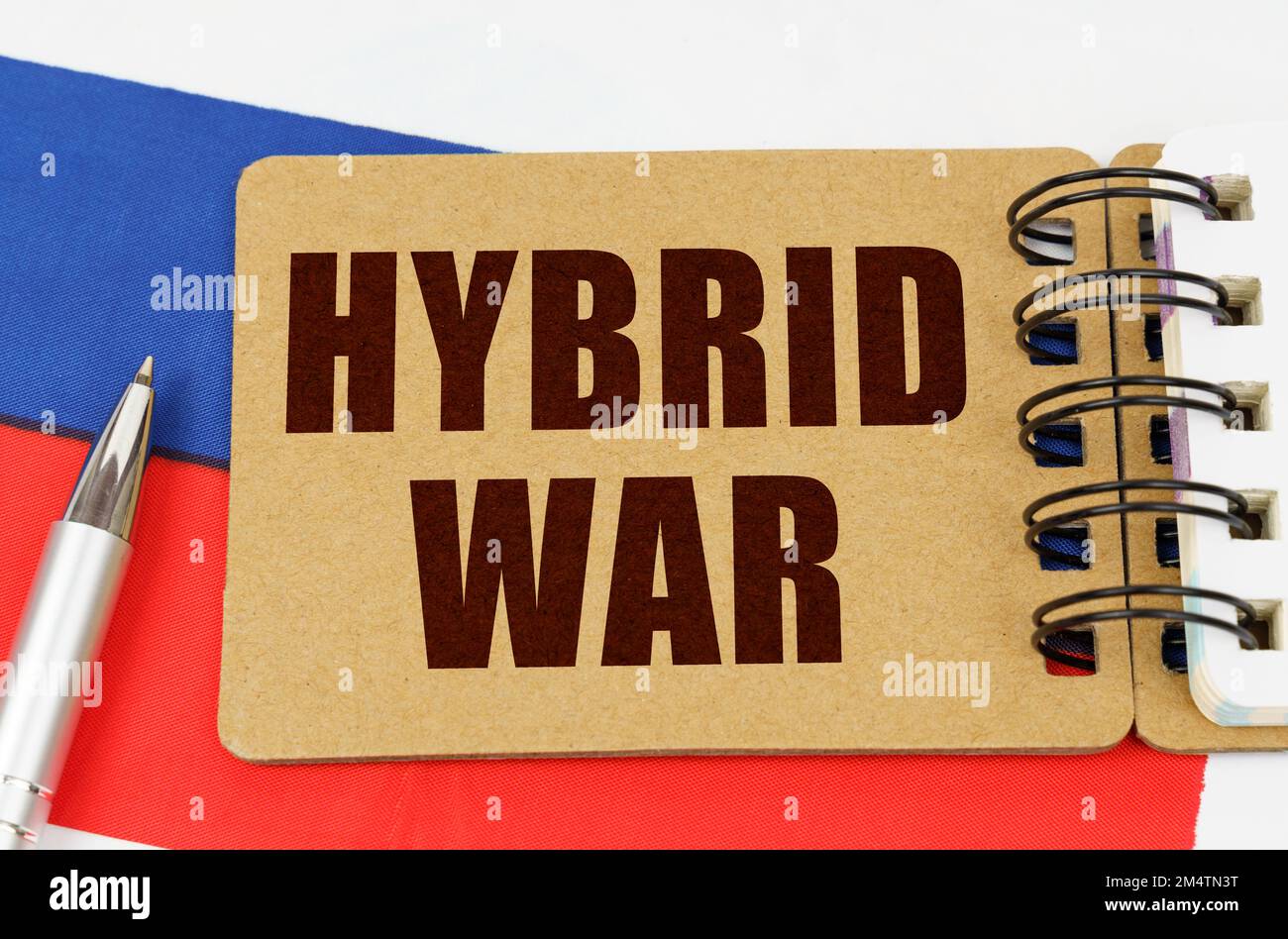 Military concept. On the flag of Russia lies a pen and a notepad with ...