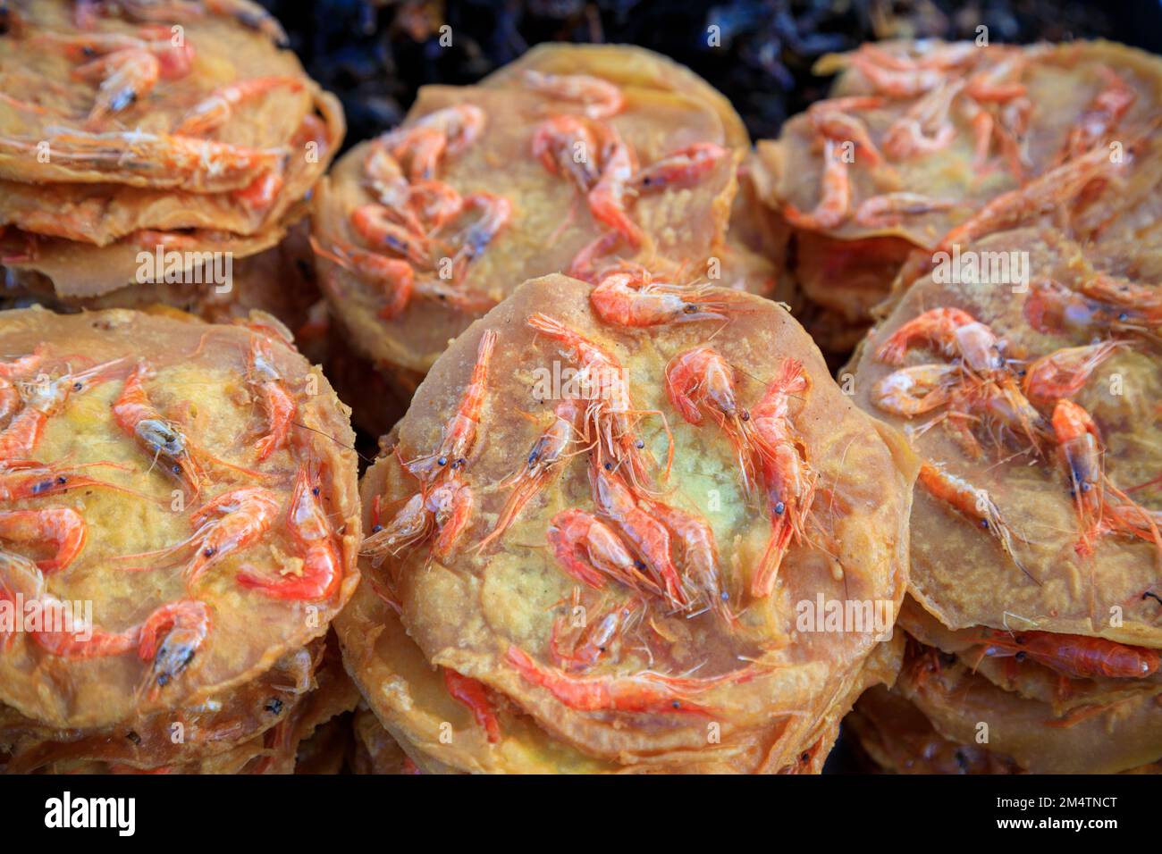 Arrangement of crispy fried shrimp prawn fritter street food at market ...