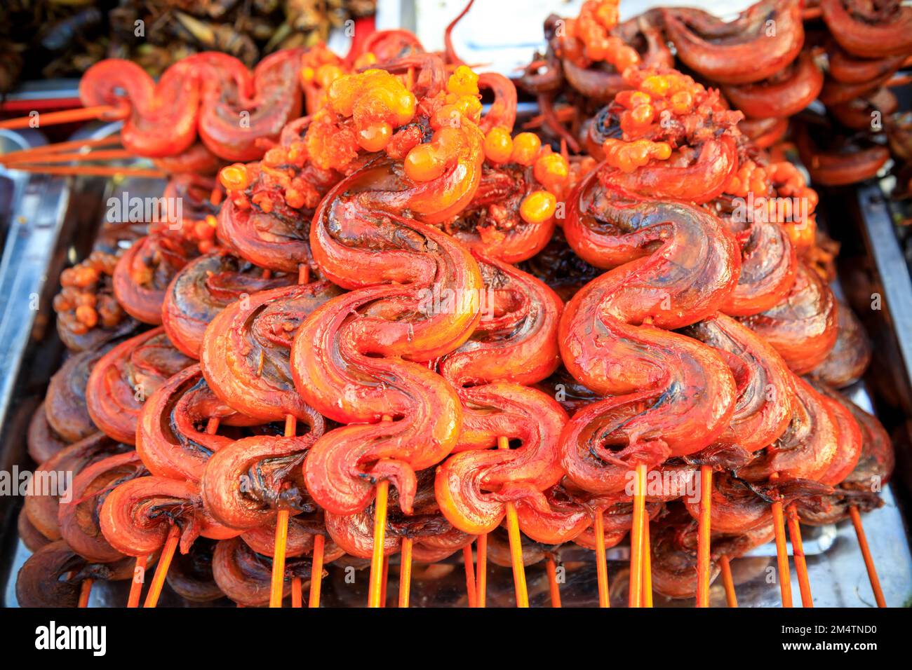 Cooked barbequed exotic street food snake in a market stall in Phnom ...