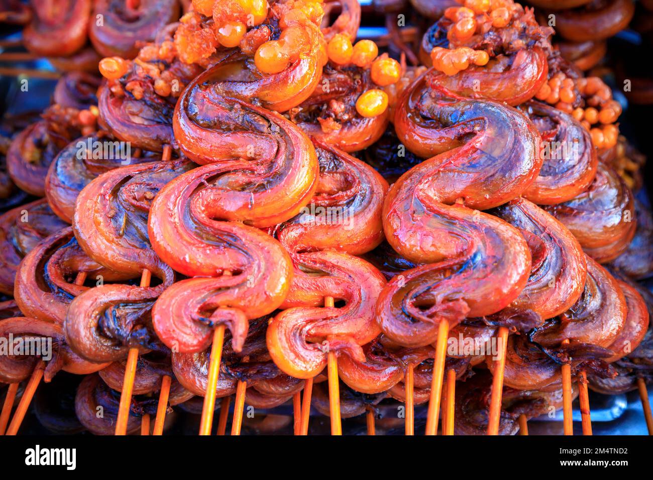 Cooked barbequed exotic street food snake in a market stall in Phnom ...