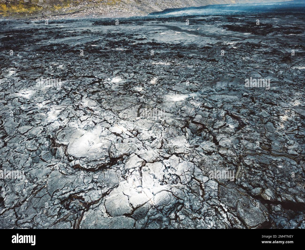 Aerial view of cooled down lava rocks with ash grey spots on the ...