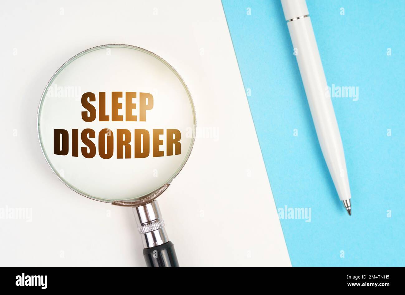 Medical concept. On a white - blue surface are a pen and a magnifying ...