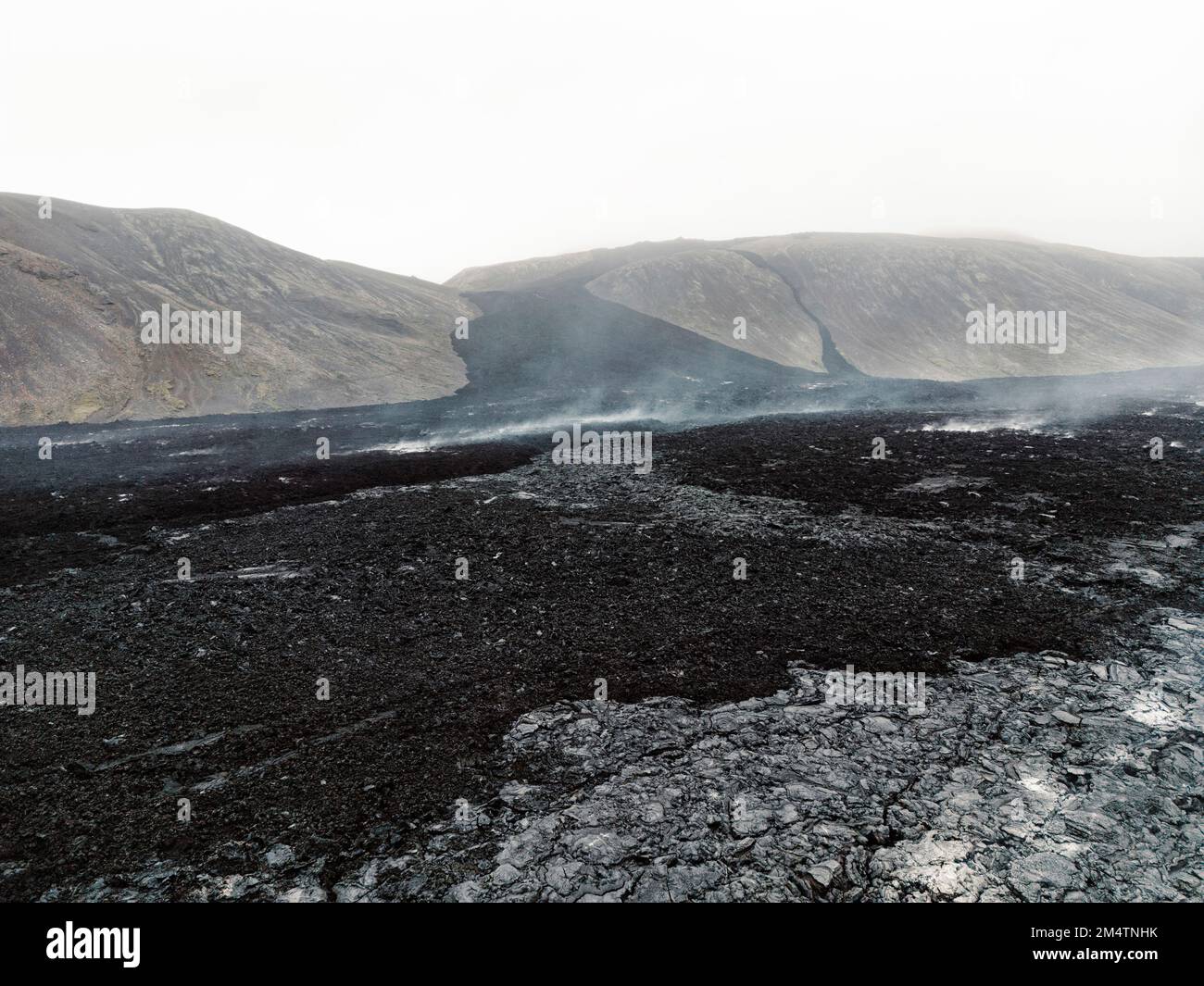 Black volcanic lava rock spread across the valley near Geldingadalir ...